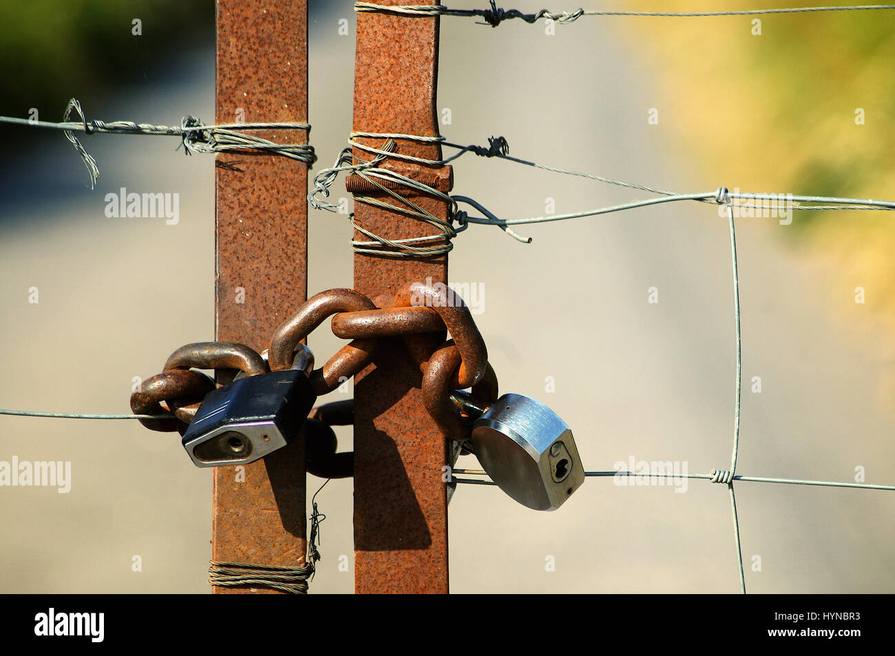 Locked gate on a rural road Stock Photo - Alamy