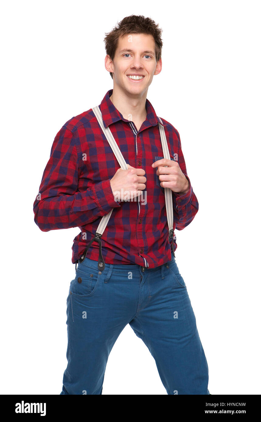 Portrait of a young man smiling and holding suspenders on isolated ...