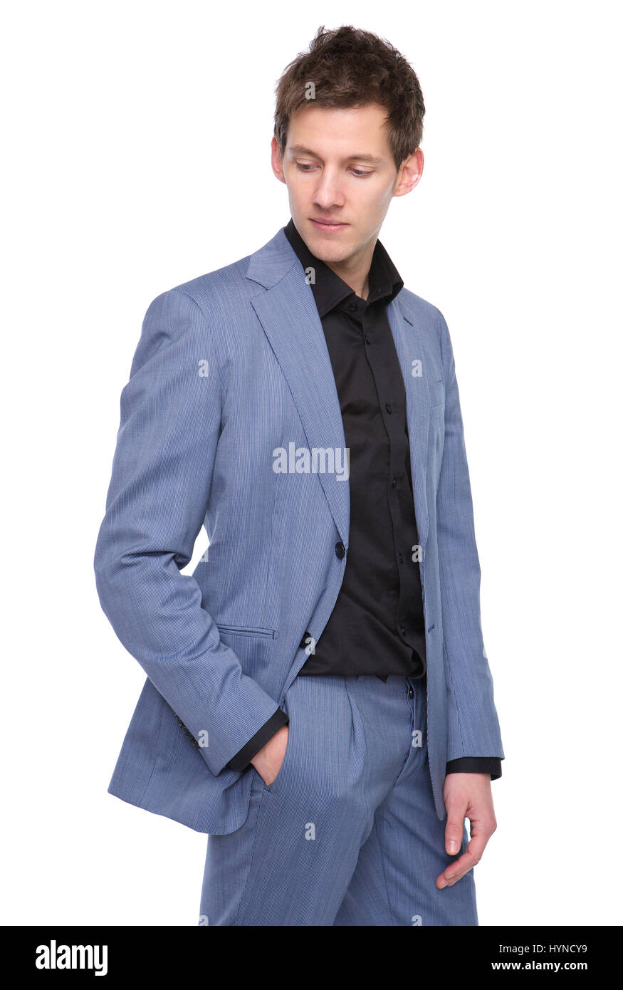 Portrait of a male fashion model in business suit standing on isolated ...