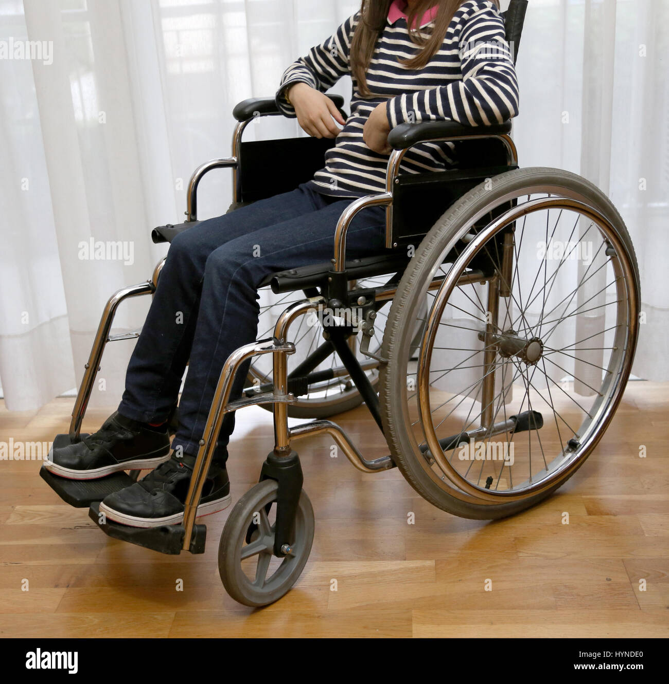 paraplegic young girl in a wheelchair in the her bedroom Stock Photo ...