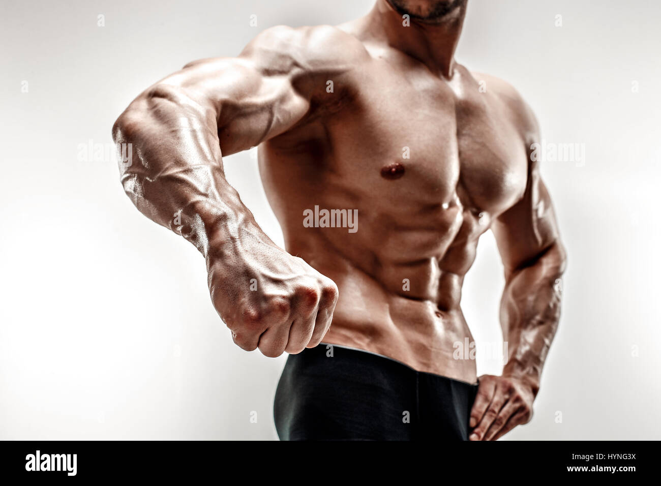 Handsome muscular bodybuilder demonstrates his fist and vein, blood ...