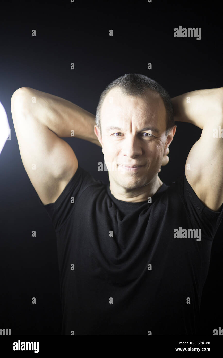 Attractive handsome slim healthy man aged in 40's in black t-shirt ...