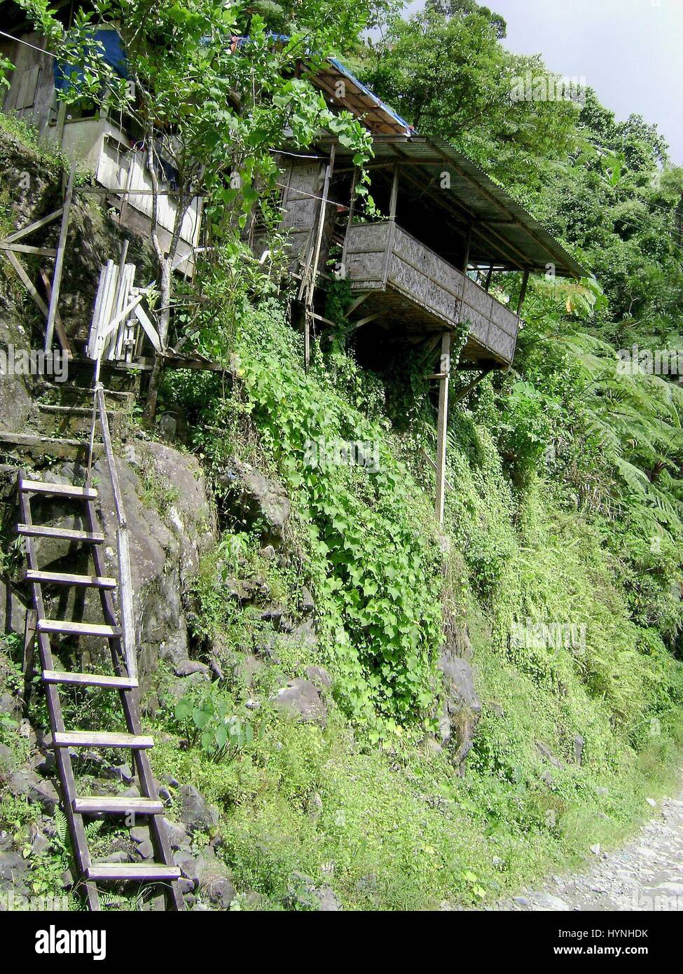 Huts on the Cliffside Crudely built huts precariously perched on the ...