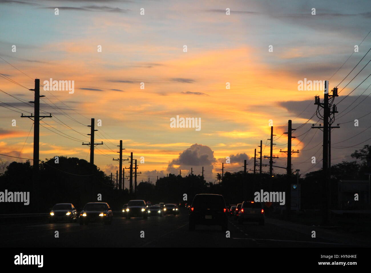Sunset in Guam A beautiful sunset backdrops a busy street in Guam Stock ...