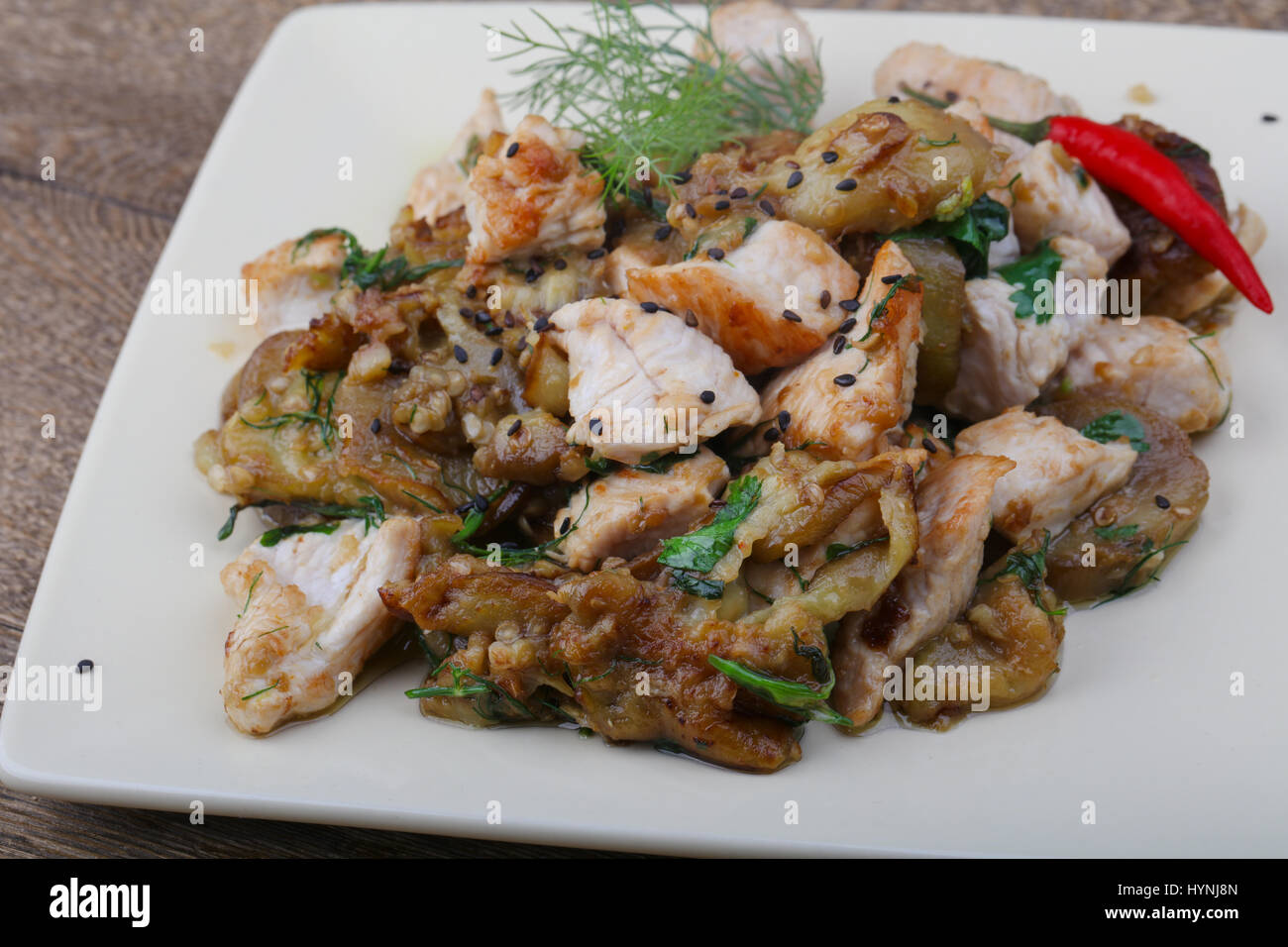 Stir-fry chicken with eggplant and sesame seeds Stock Photo - Alamy
