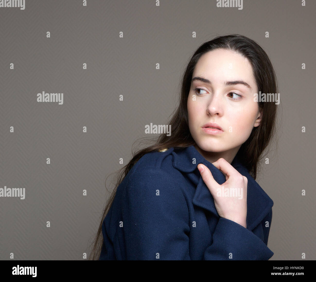 Close up horizontal portrait of a beautiful young woman looking over ...