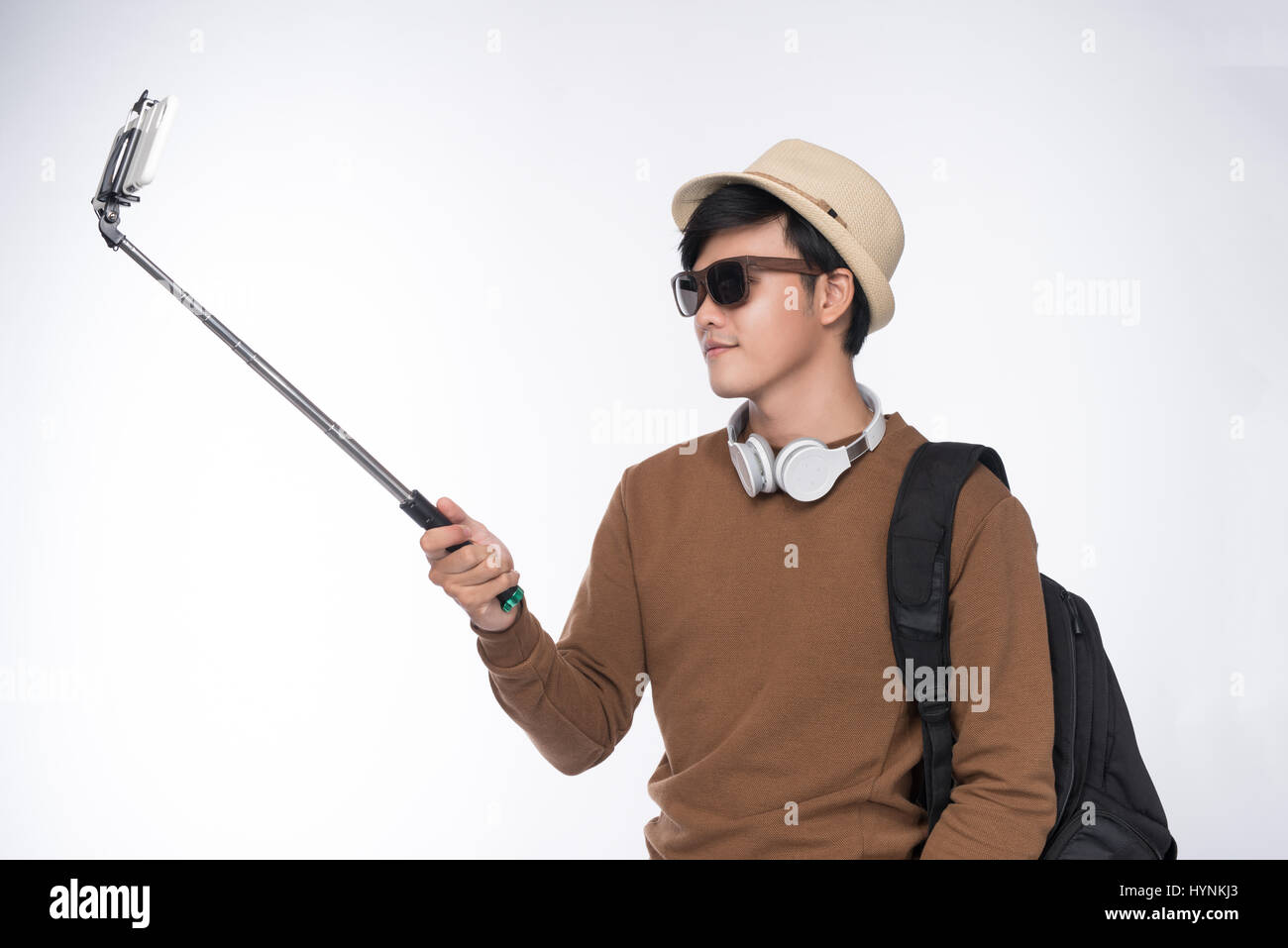 Happy young asian man taking self portrait photography through smart ...