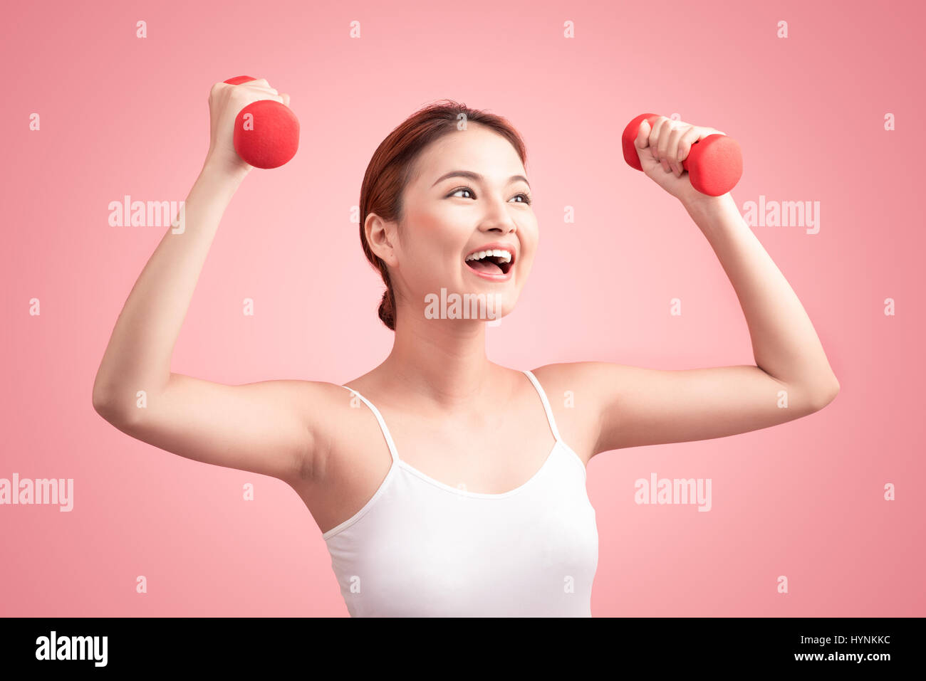 Woman Lifting Weights. Fitness woman lifting weights smiling happy on ...