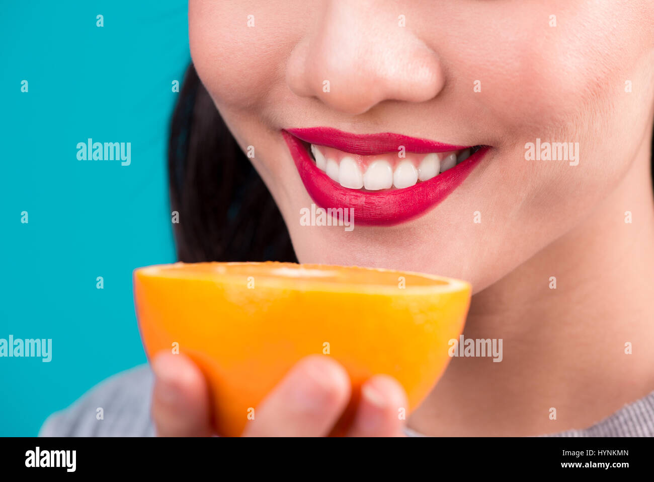 Healthy food. Close-up of dmiling lovely pinup asian girl holding ...
