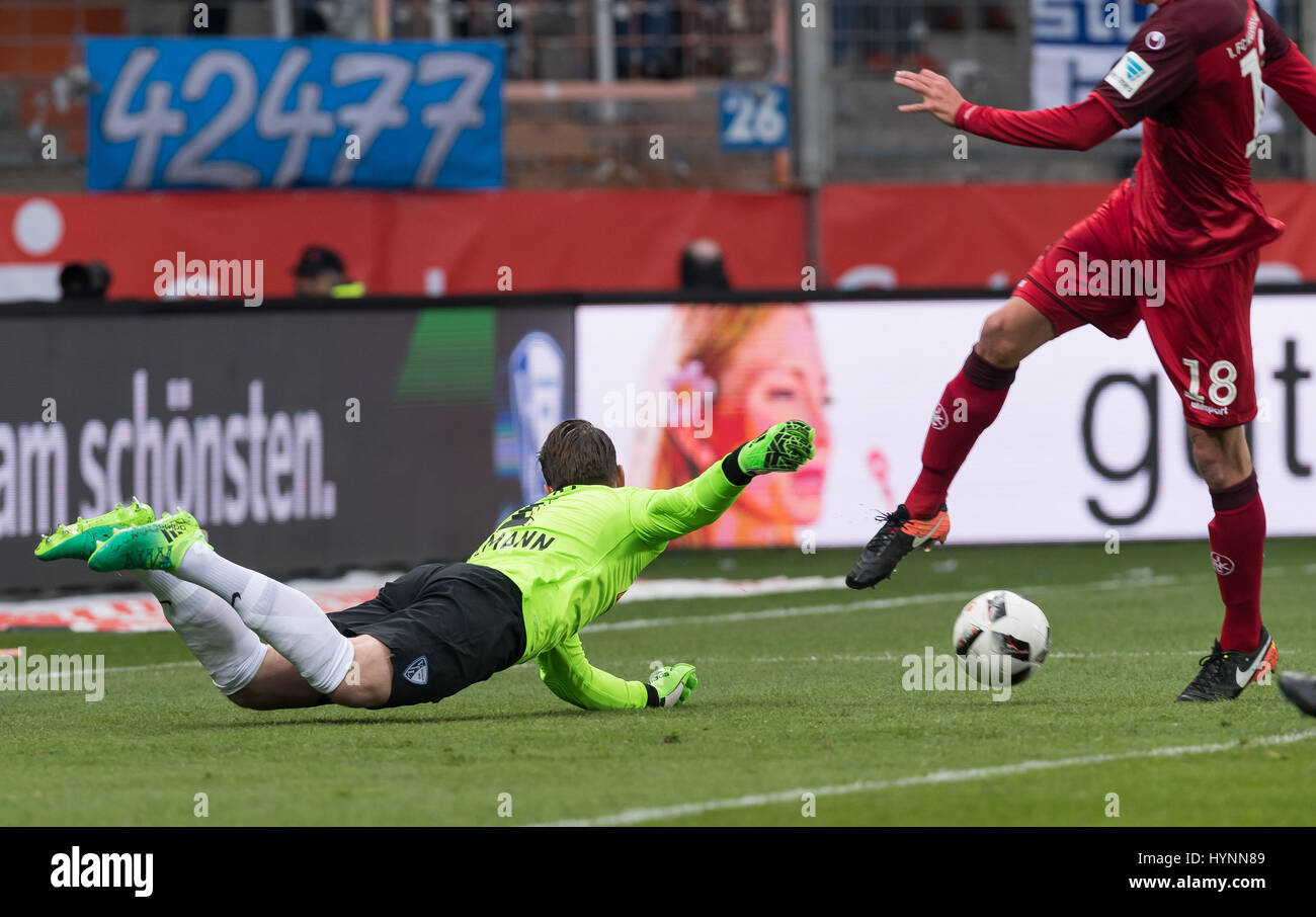 Bochum's goalkeeper Manuel Riemann (L) also blocks the follow-up shot ...
