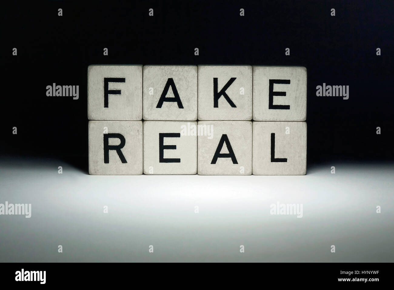 ILLUSTRATION - The words "FAKE" and "REAL" are spelled out next to each ...