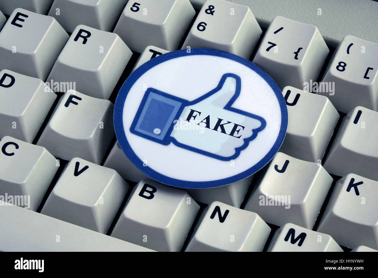 ILLUSTRATION - A "Like" button with the word "FAKE" on it lies on top ...