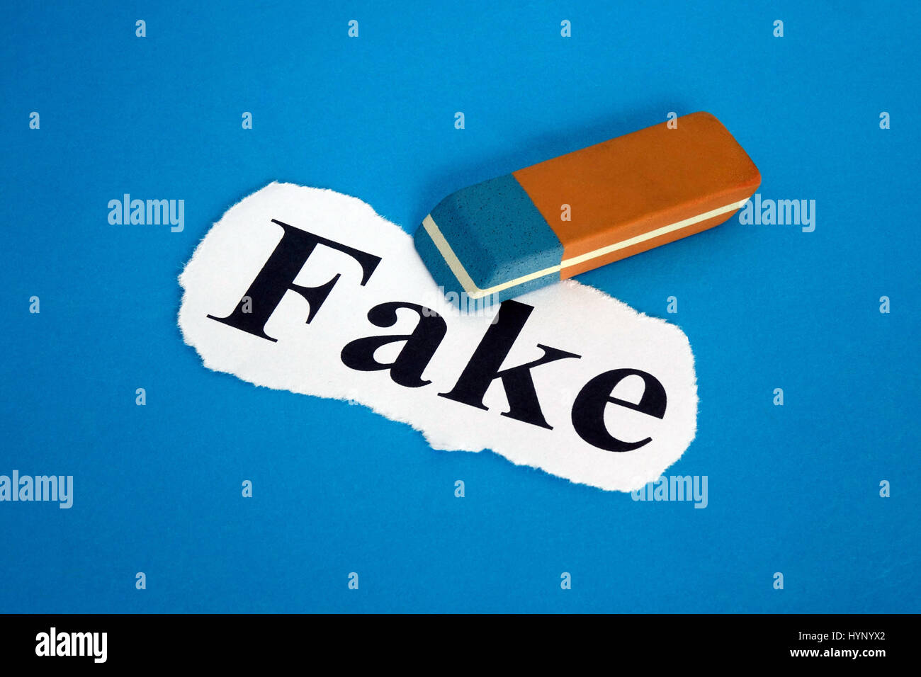 ILLUSTRATION - A rubber lies on top of a piece of paper with "Fake ...