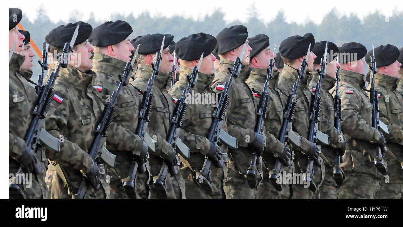 Polish soldiers march in formation and sing their national anthem ...