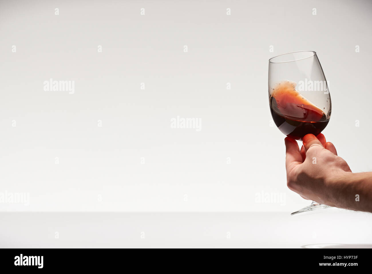 Red wine celebration background. Hand make toast with red wine close-up ...