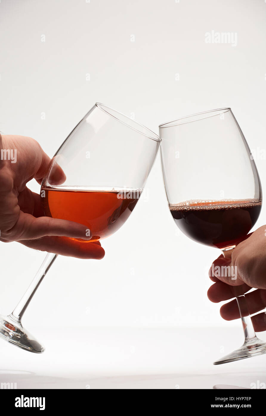 Couple make cheers with red wine glasses isolated on white background ...