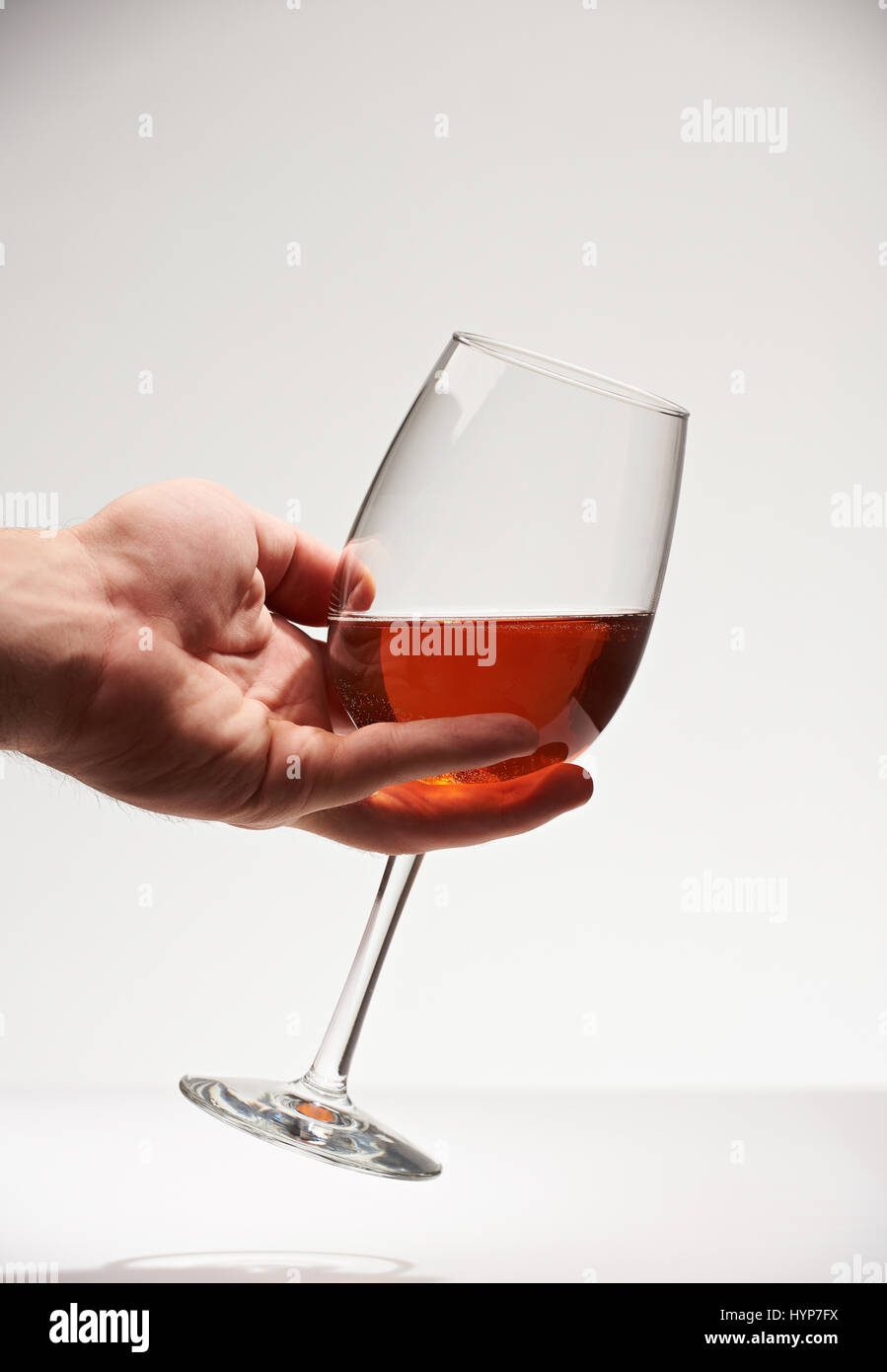 Red wine in glass beverage isolated on white background. Close-up hand ...