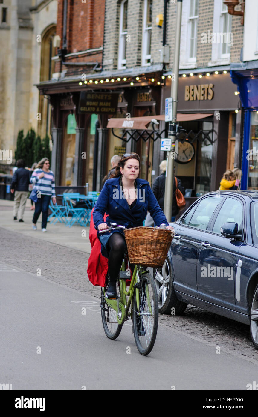 Woman lady cyclist riding a bike cycle bicycle in Cambridge ...