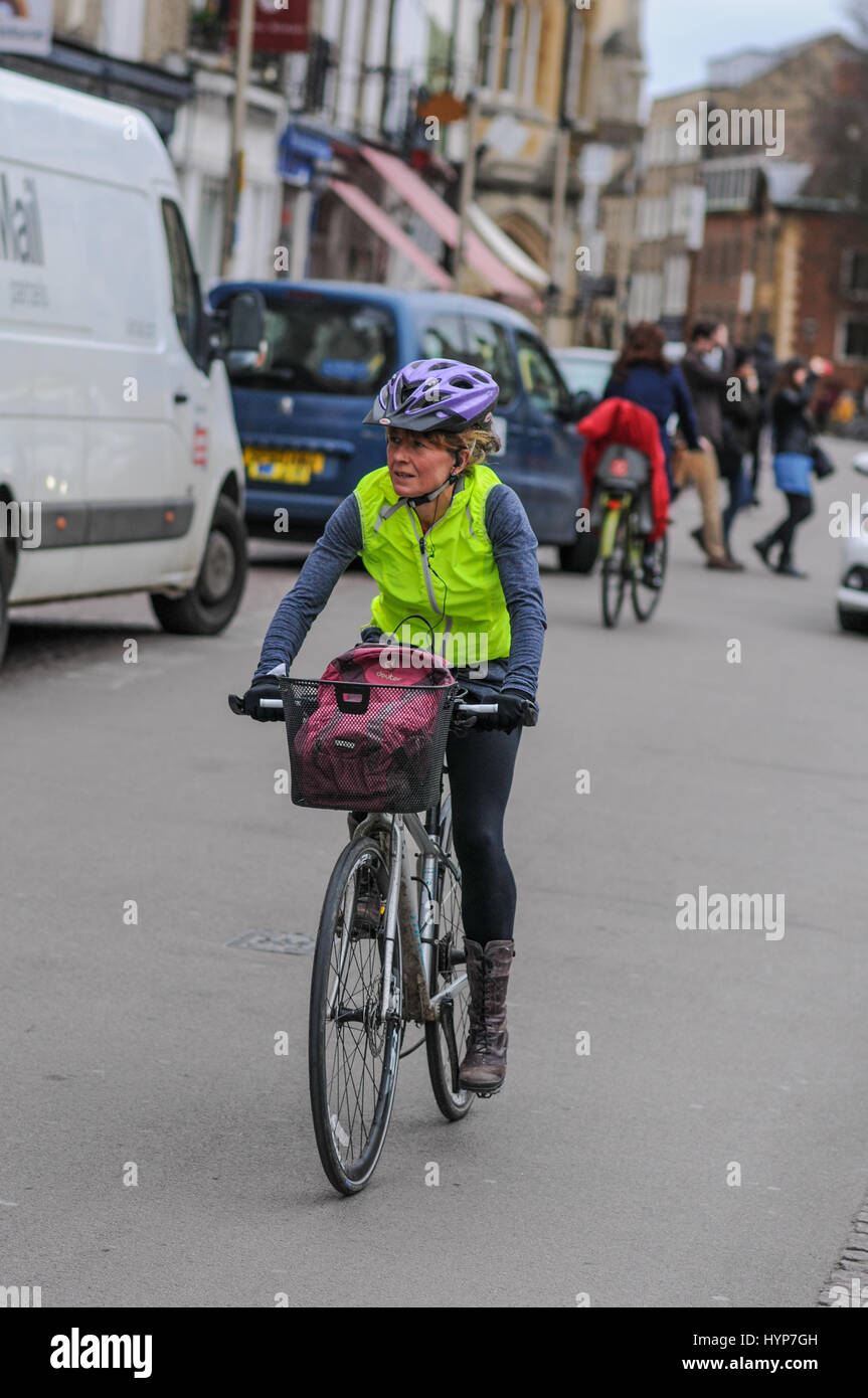 Woman lady cyclist riding a bike cycle bicycle in Cambridge ...