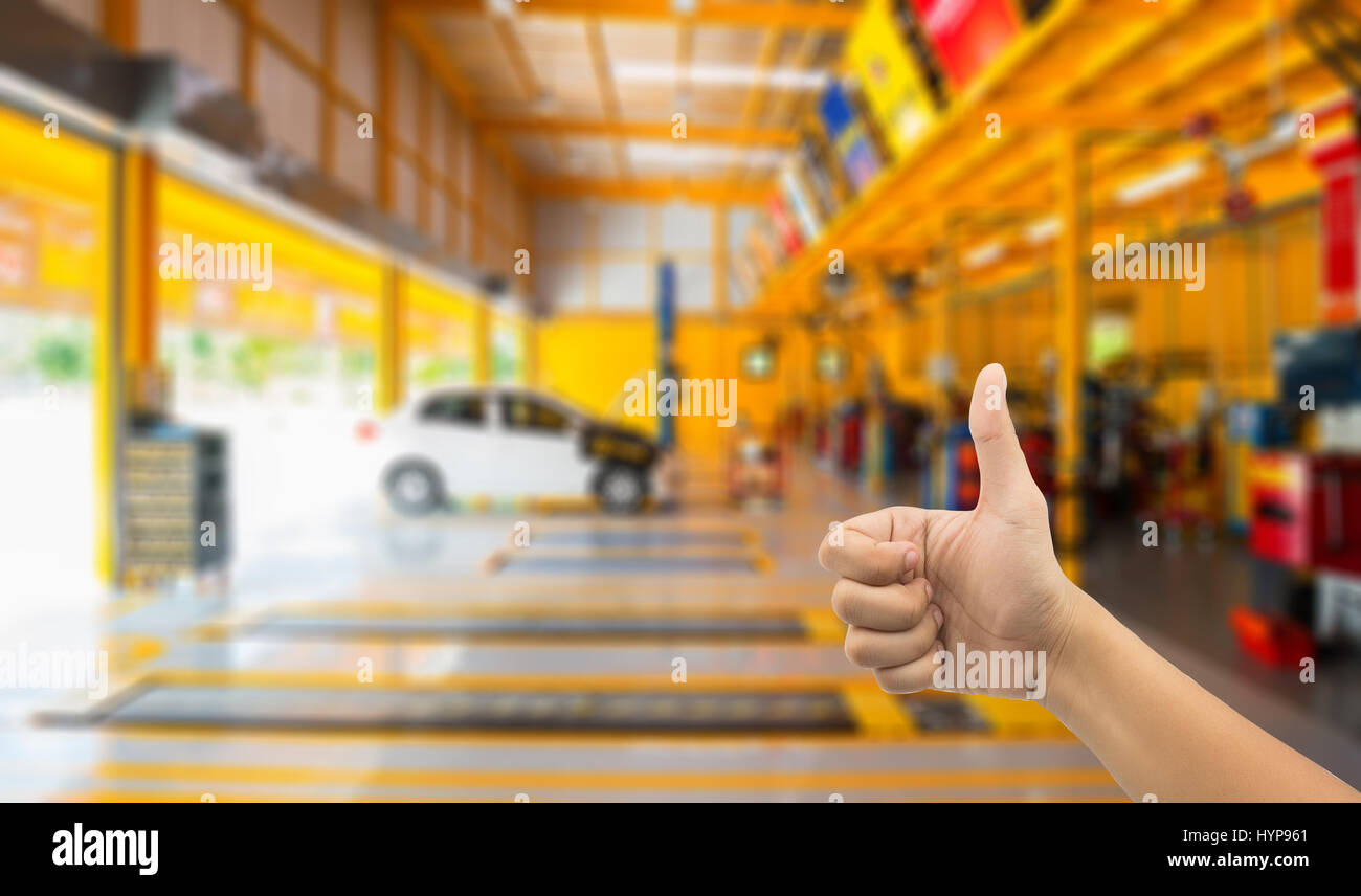 Good hand with blur garage or car repair background Stock Photo - Alamy