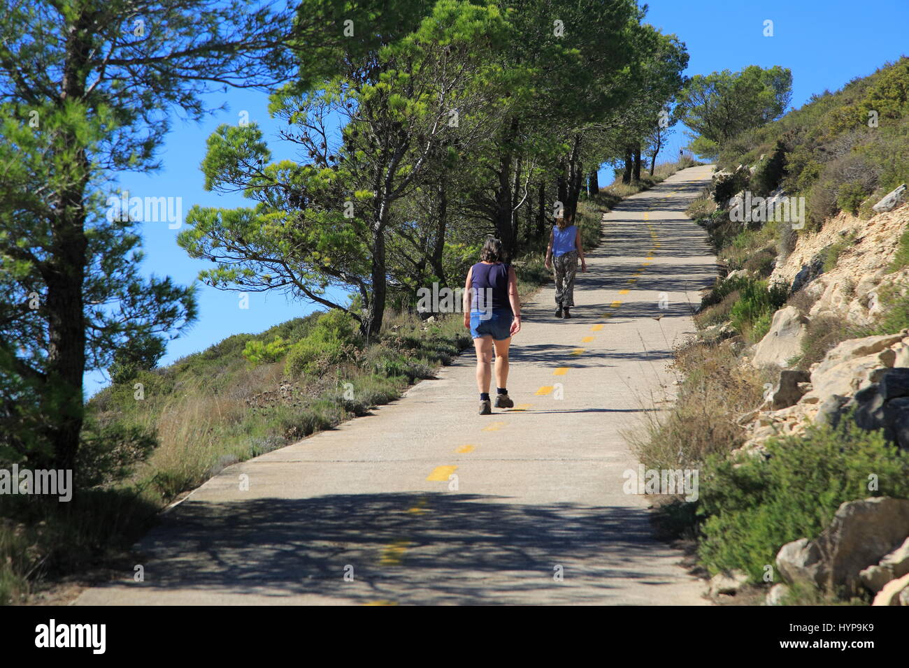 Two women walking along mountain path from Coll de Rates, Tarbena ...