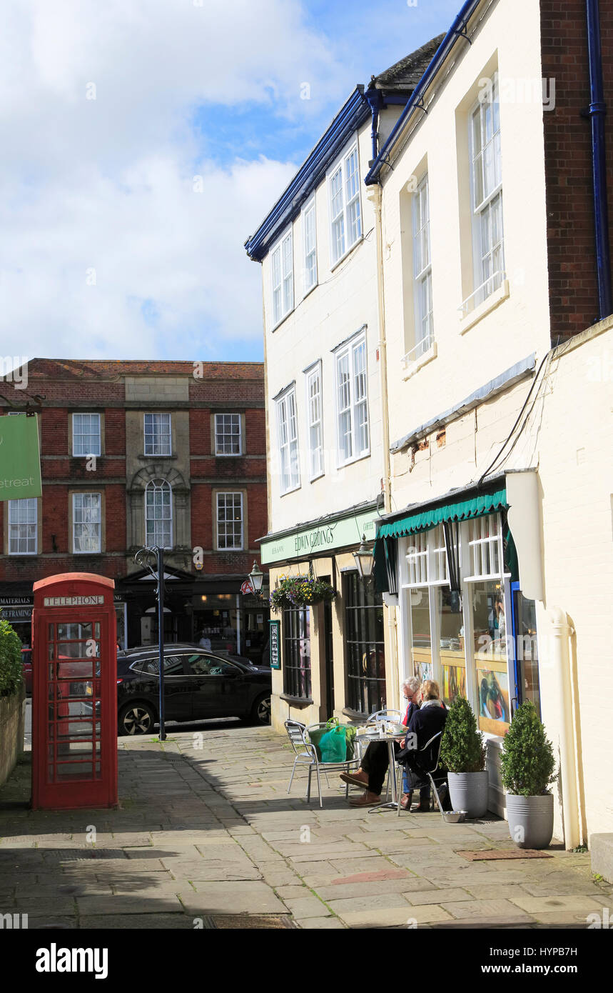 People sitting outside cafe in quiet back street, Devizes, Wiltshire ...