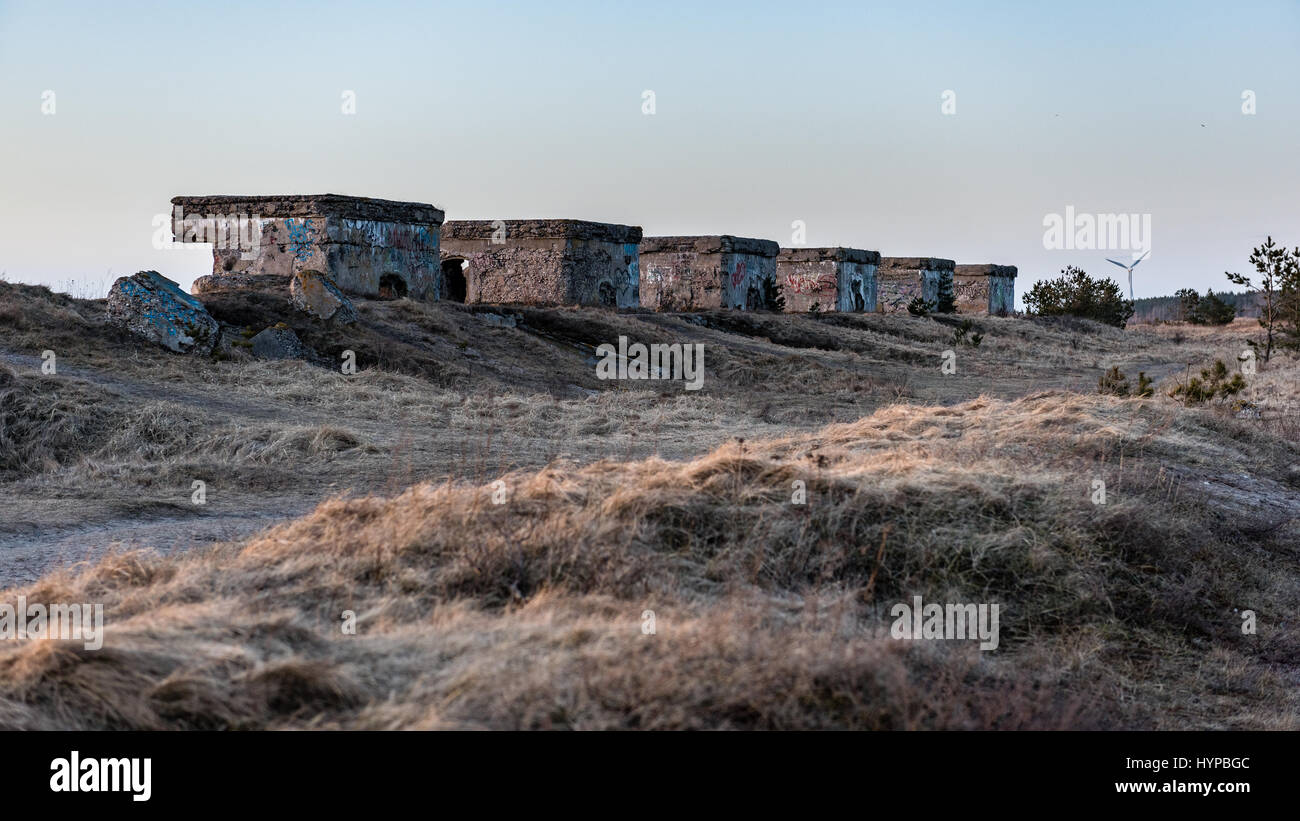 old war fort ruins on the beach with high waves in sunset. Liepaja ...