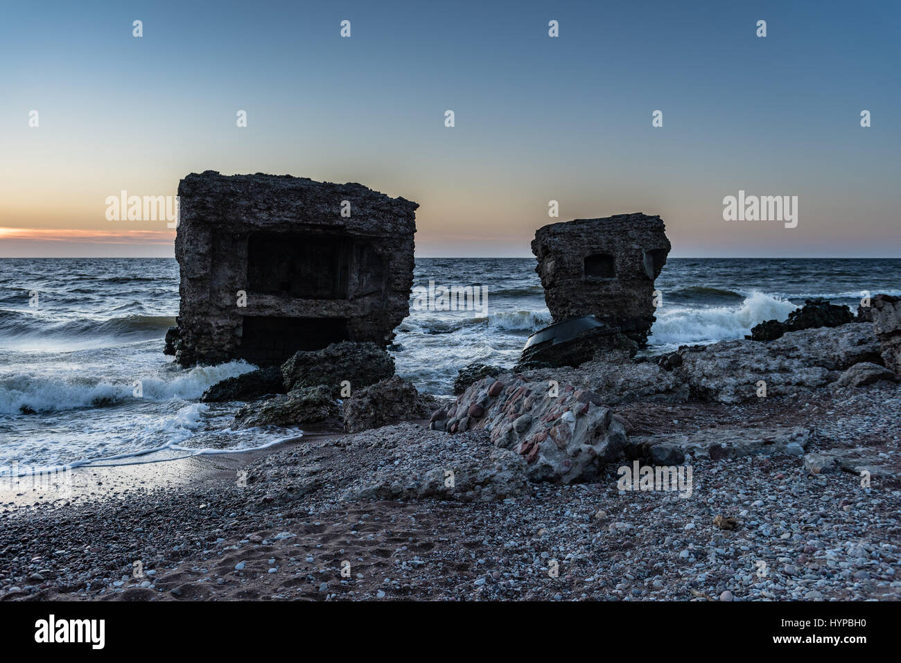 old war fort ruins on the beach with high waves in sunset. Liepaja ...