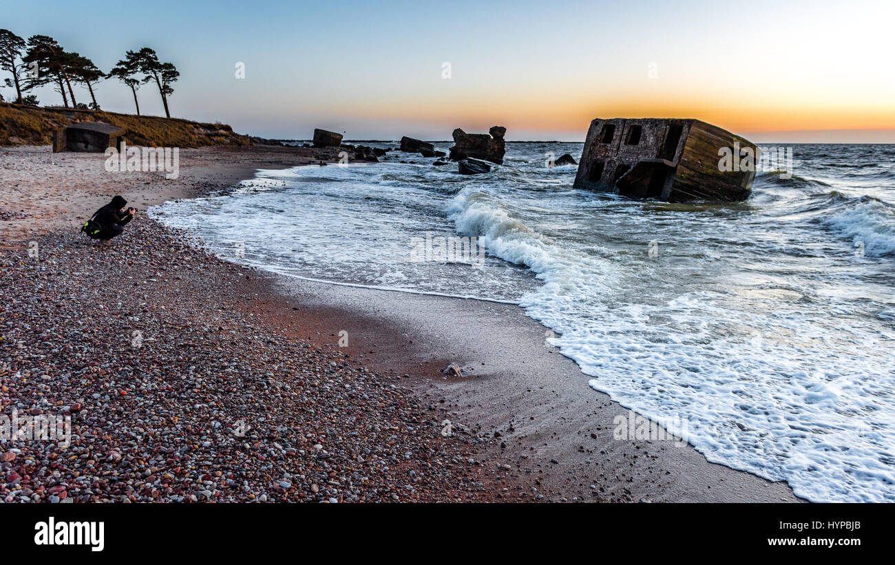old war fort ruins on the beach with high waves in sunset. Liepaja ...