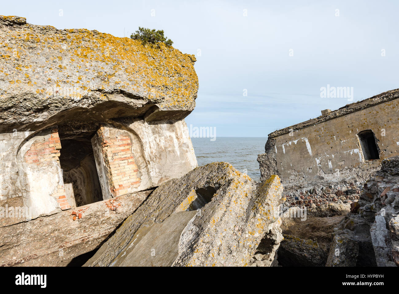 old war fort ruins on the beach with high waves in sunset. Liepaja ...