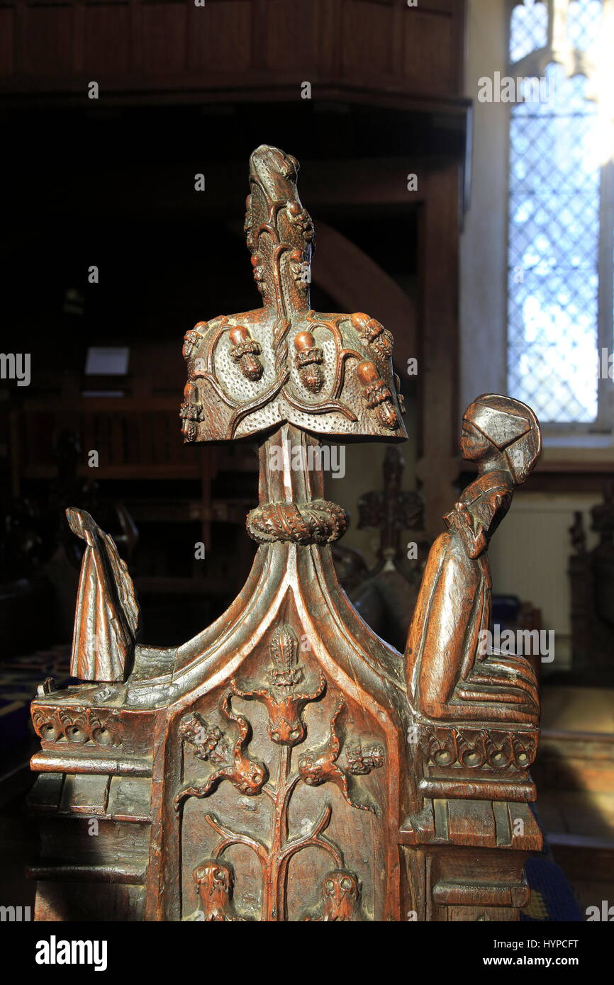 Ornately decorated wooden pew end of woman praying, Ufford church ...