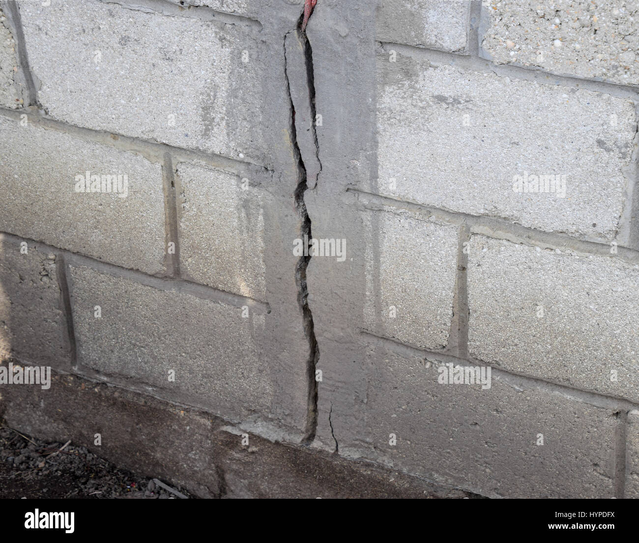A crack in the concrete wall. The destruction of the wall from the gray ...