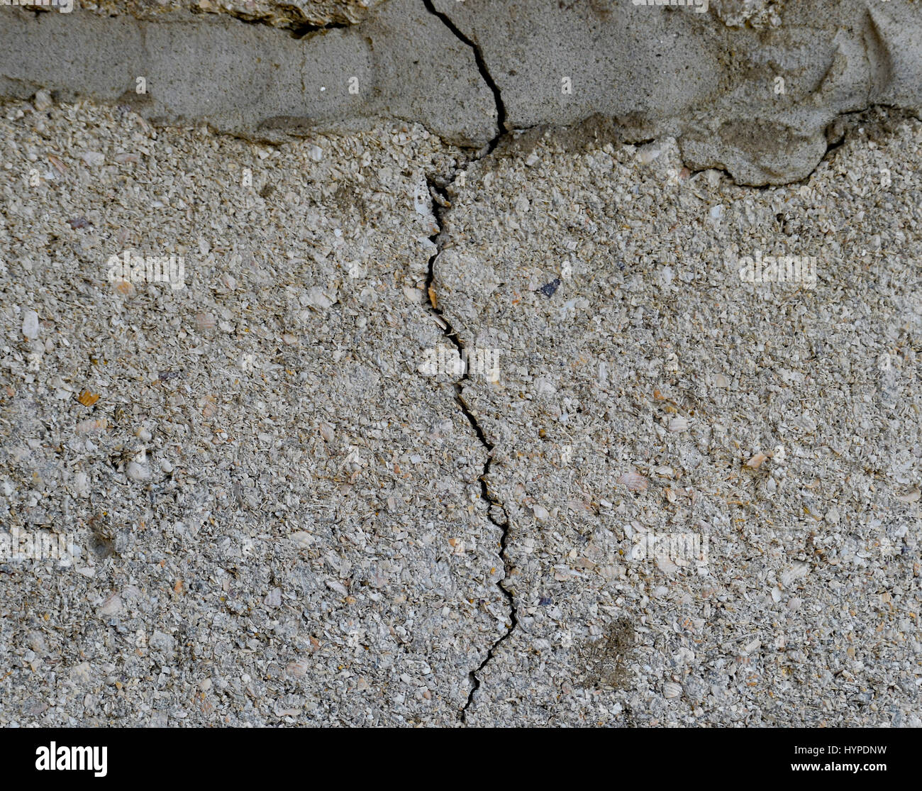 A crack in the concrete wall. The destruction of the wall from the gray ...