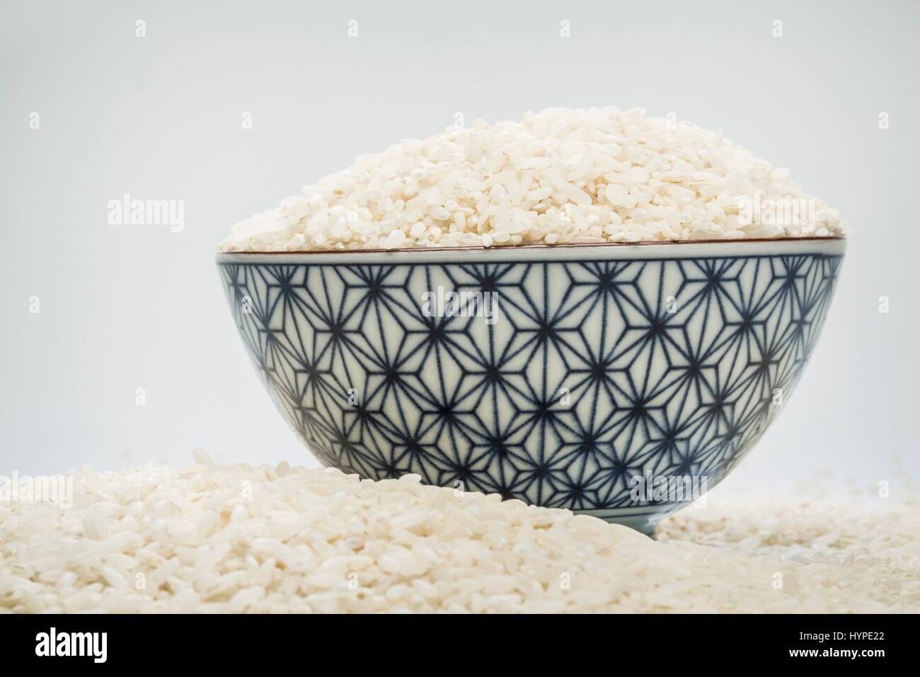Rice bowl surrounded with rice Stock Photo - Alamy