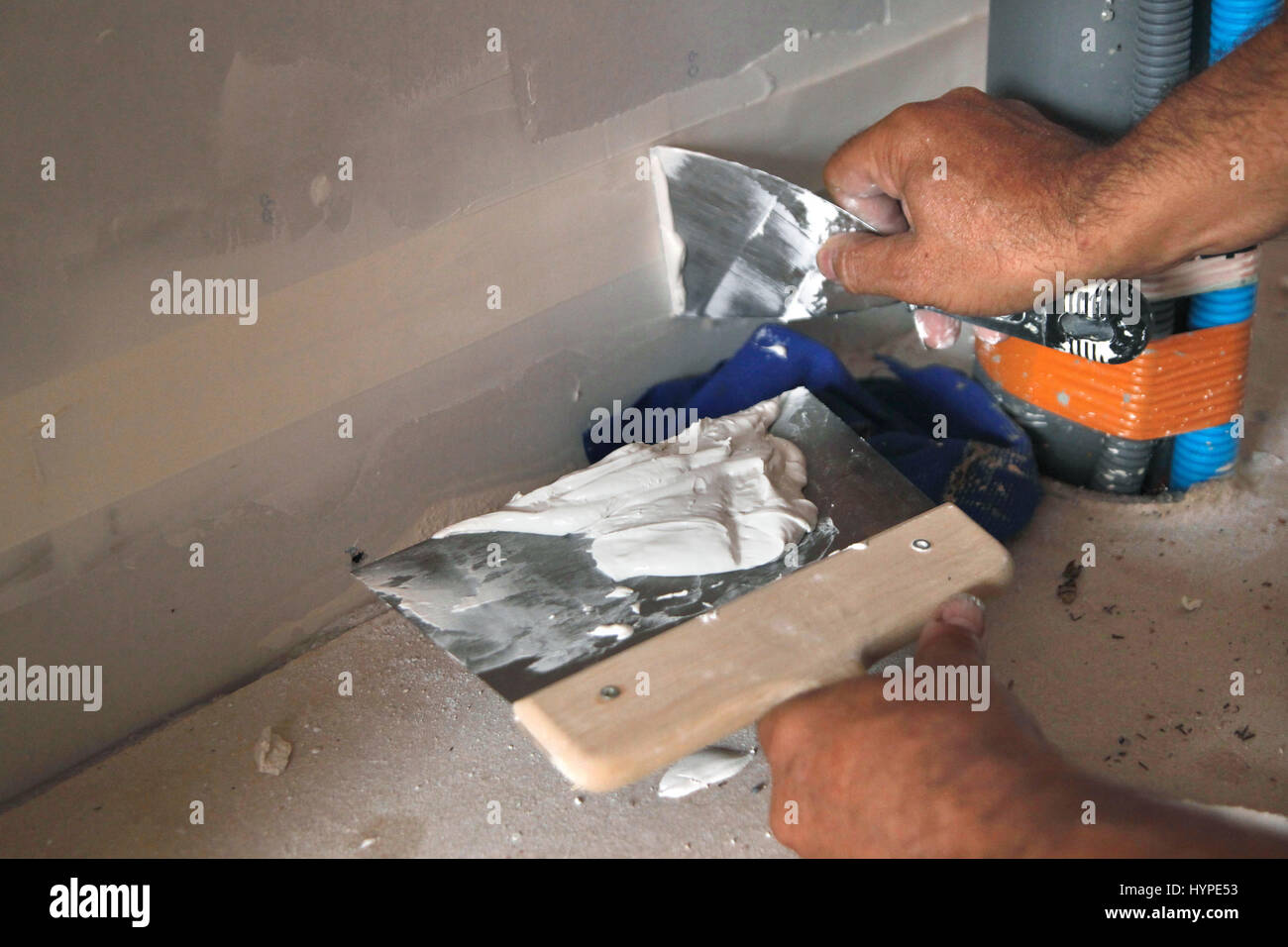 France,House building, plasterboard work, applying coating to strips ...