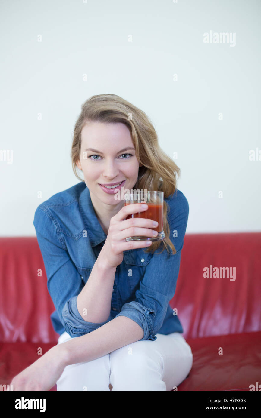 Pretty blonde on couch drinking hi-res stock photography and images - Alamy