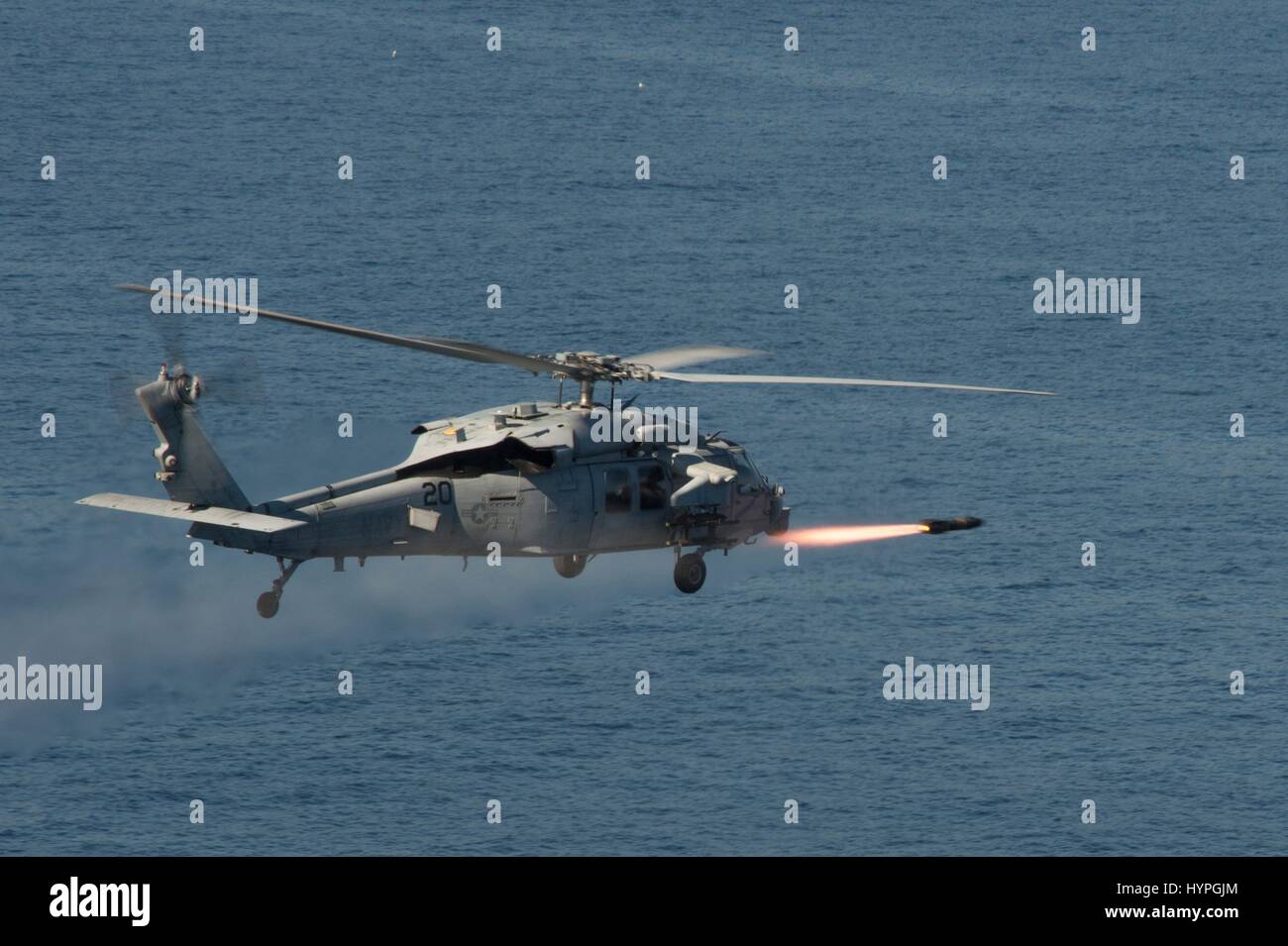 A USN MH-60S Seahawk helicopter launches an AGM-114N Hellfire missile ...