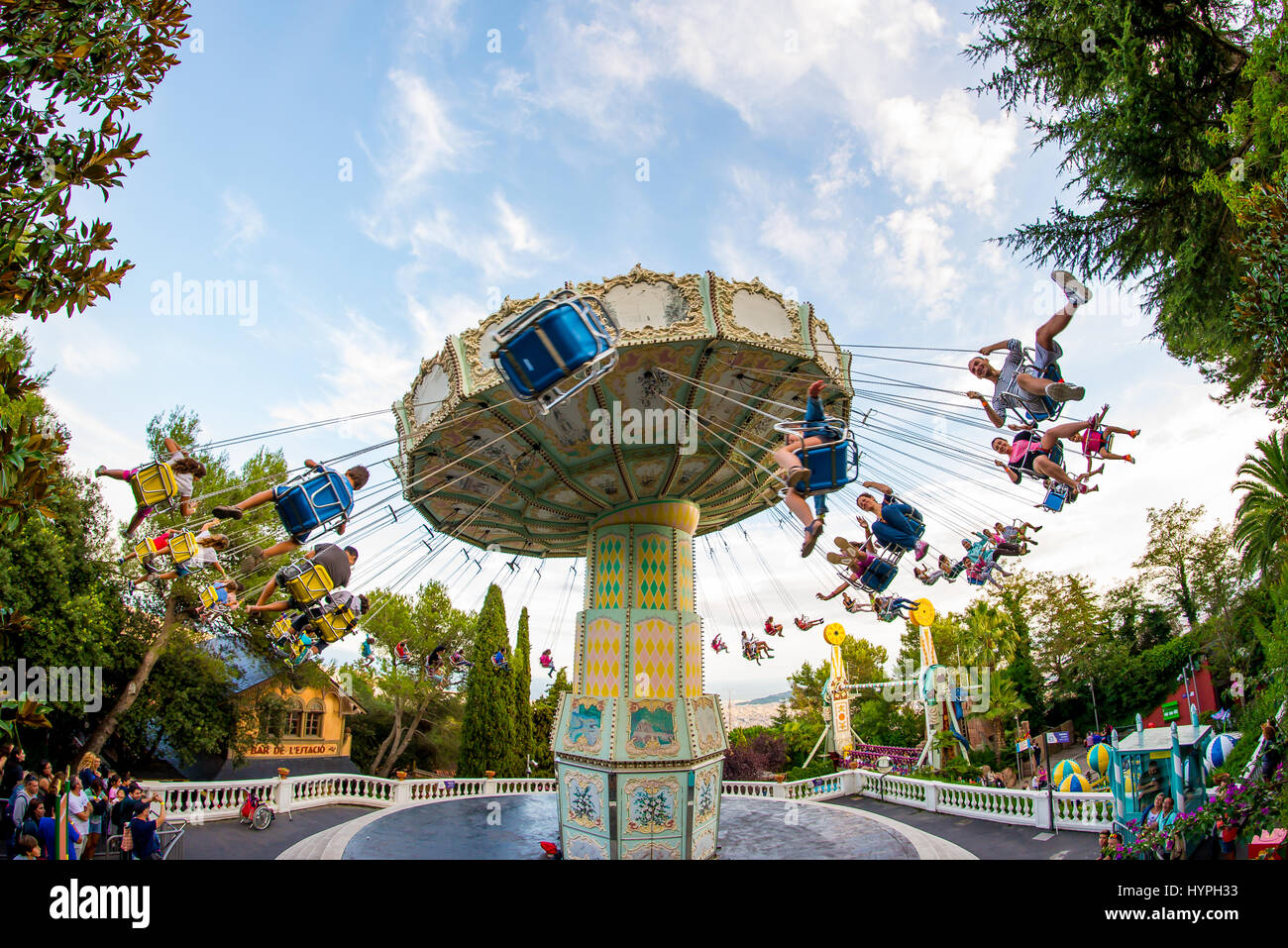 BARCELONA - SEP 5: People have fun at the carousel flying swing ride ...