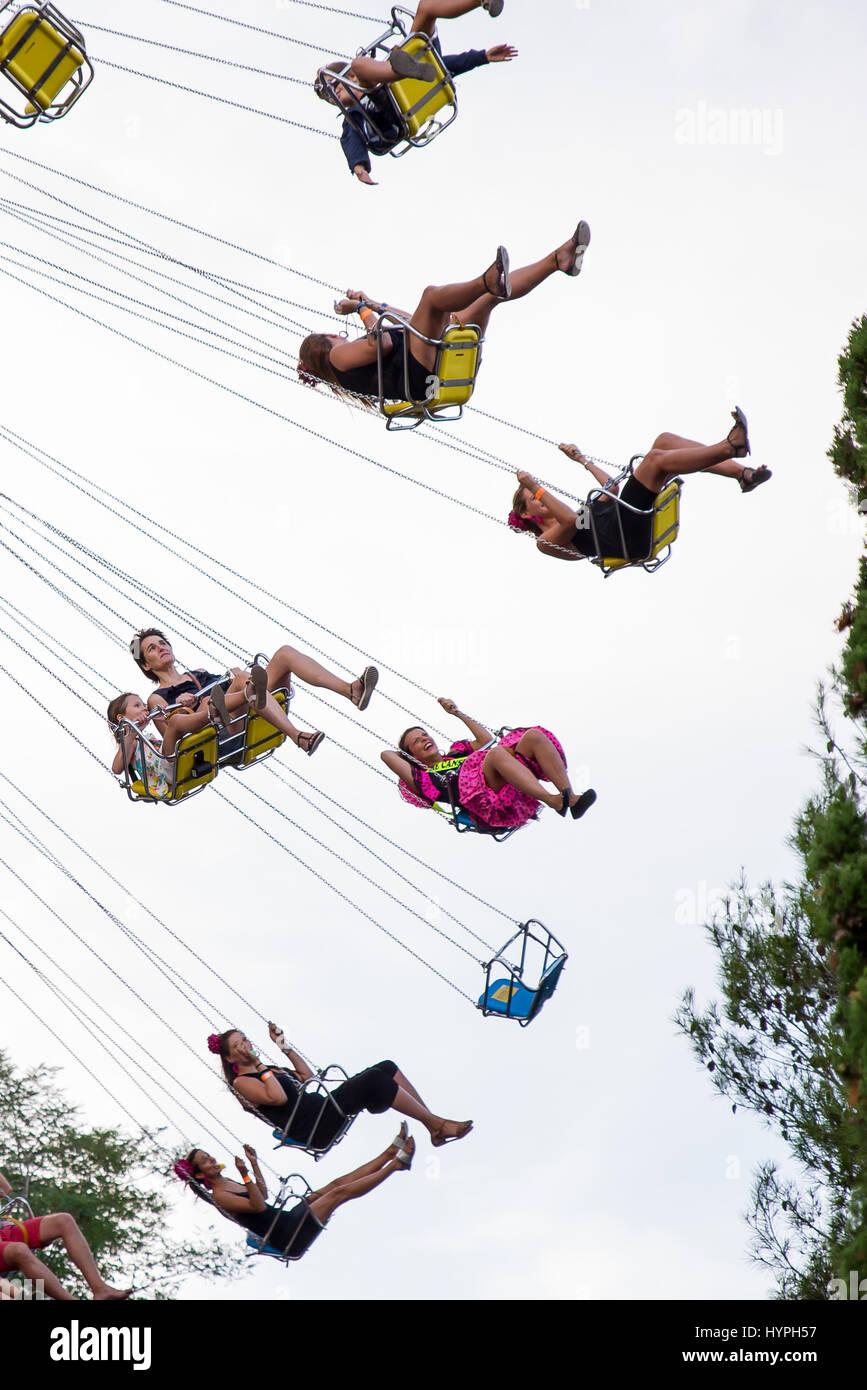 BARCELONA - SEP 5: People have fun at the carousel flying swing ride ...