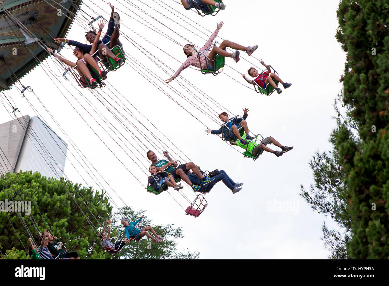 BARCELONA - SEP 5: People have fun at the carousel flying swing ride ...