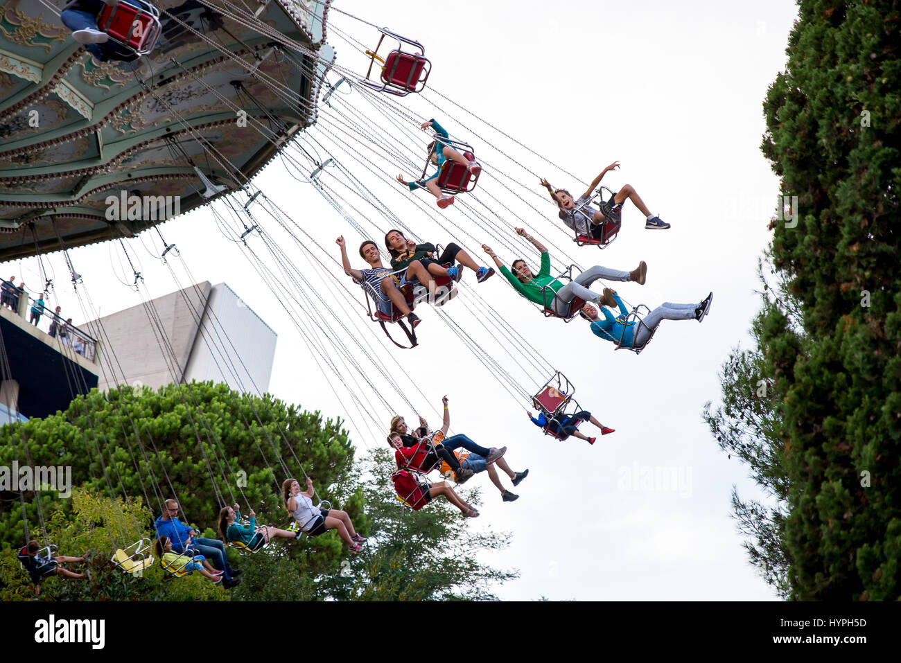 BARCELONA - SEP 5: People have fun at the carousel flying swing ride ...