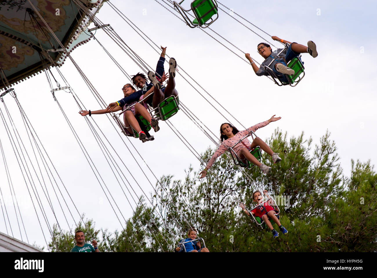 BARCELONA - SEP 5: People have fun at the carousel flying swing ride ...