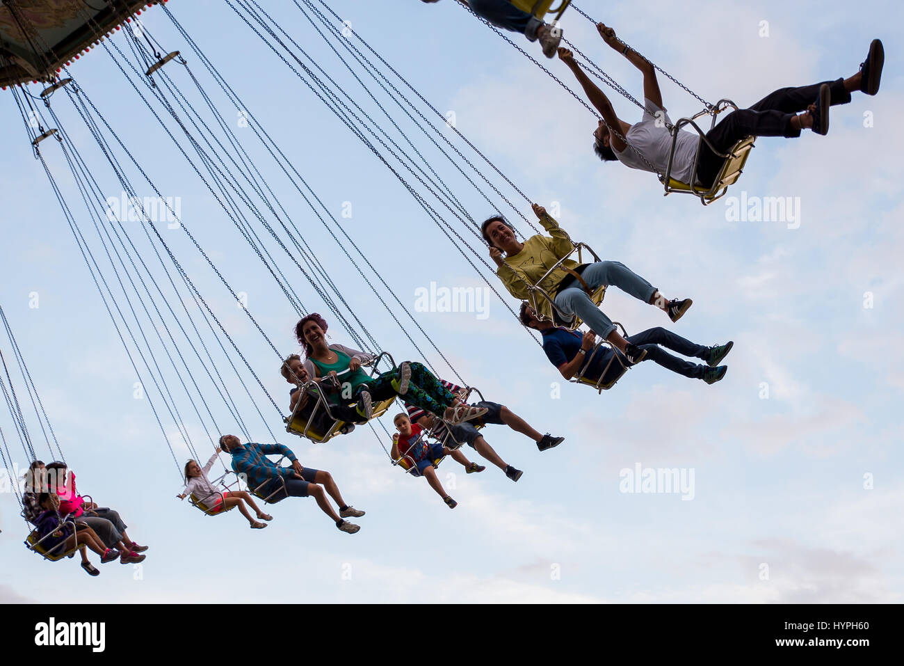 BARCELONA - SEP 5: People have fun at the carousel flying swing ride ...