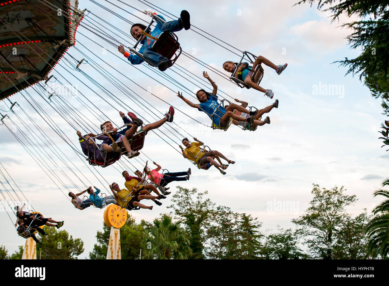 BARCELONA - SEP 5: People have fun at the carousel flying swing ride ...