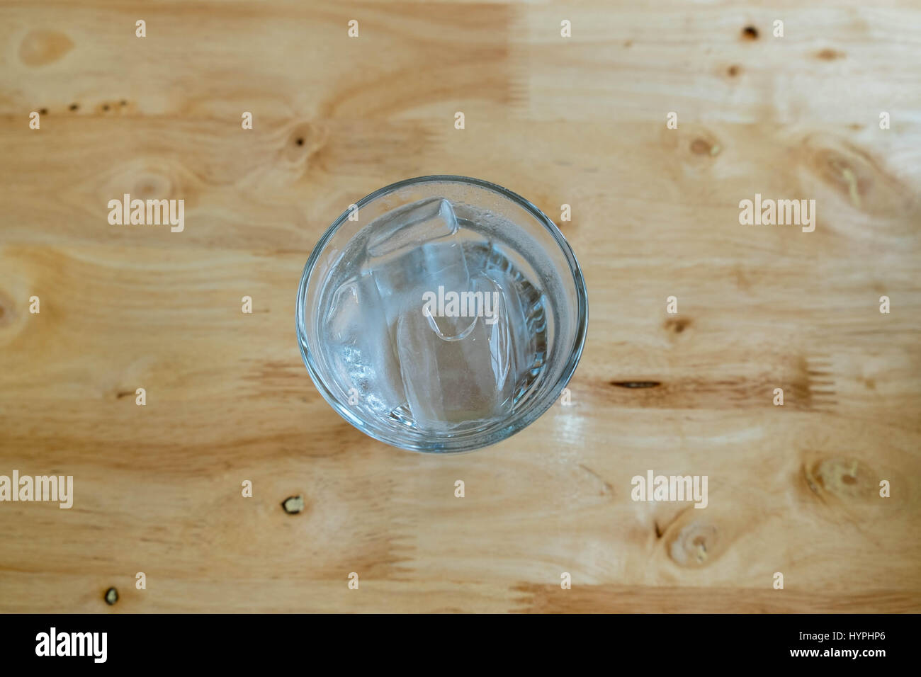 A Glass of Water on Plain Wood Table Stock Photo - Alamy
