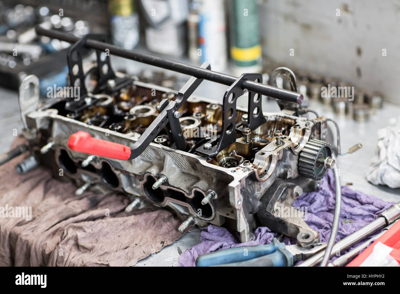 Car mechanic in garage with old car engine piston And valve Stock Photo ...