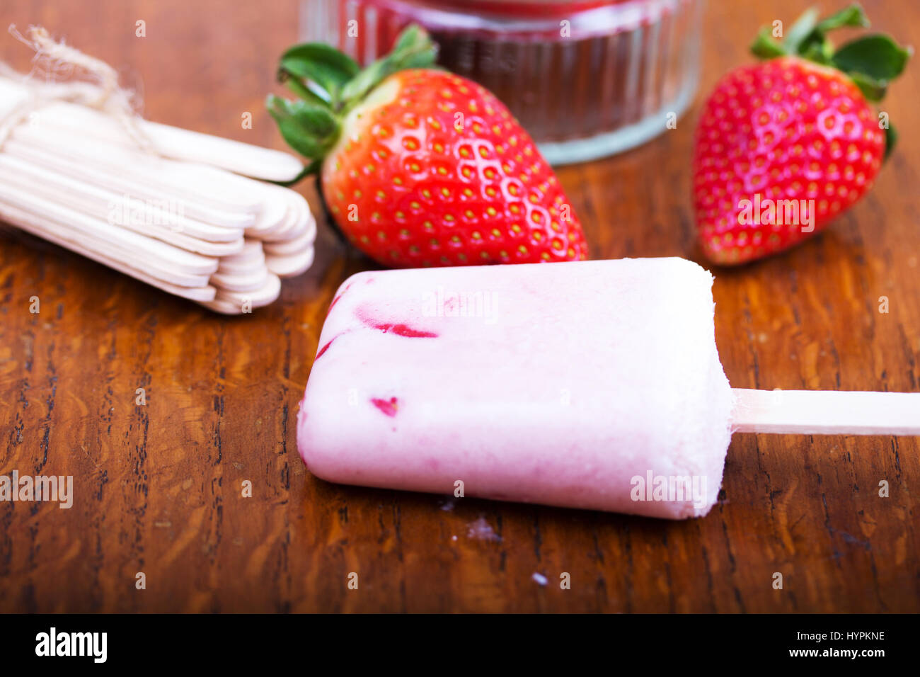 Homemade strawberry ice lolly on a rustic background Stock Photo - Alamy
