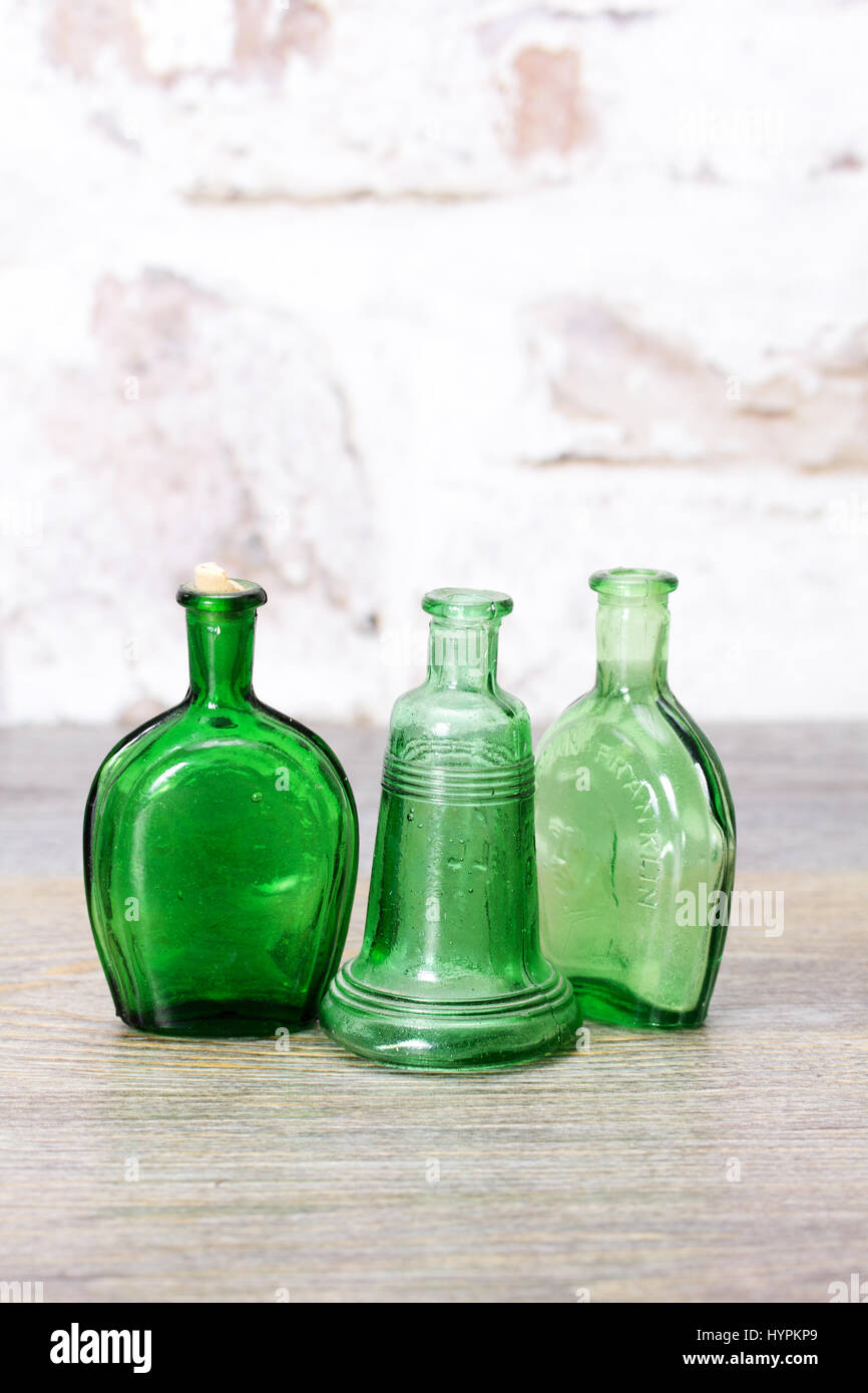 Selection of coloured glass bottles on a rustic background Stock Photo ...