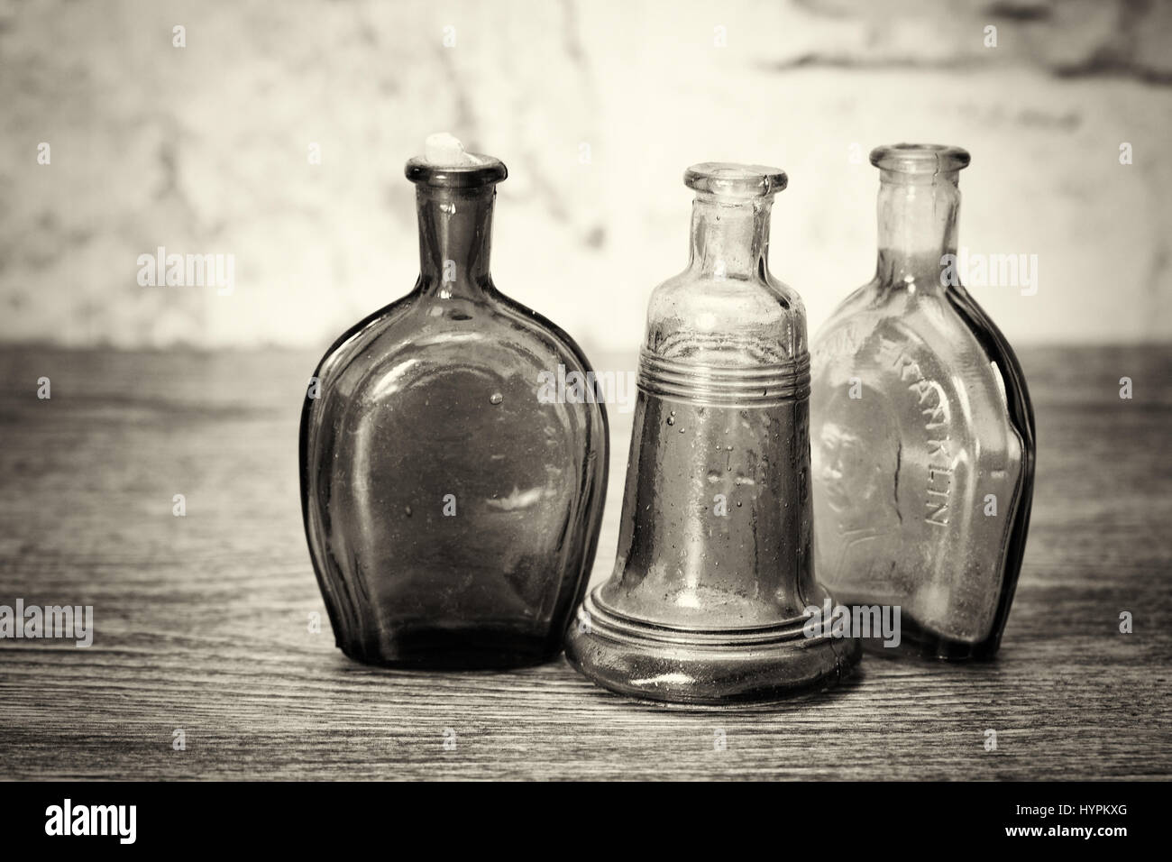 Selection of coloured glass bottles on a rustic background Stock Photo ...