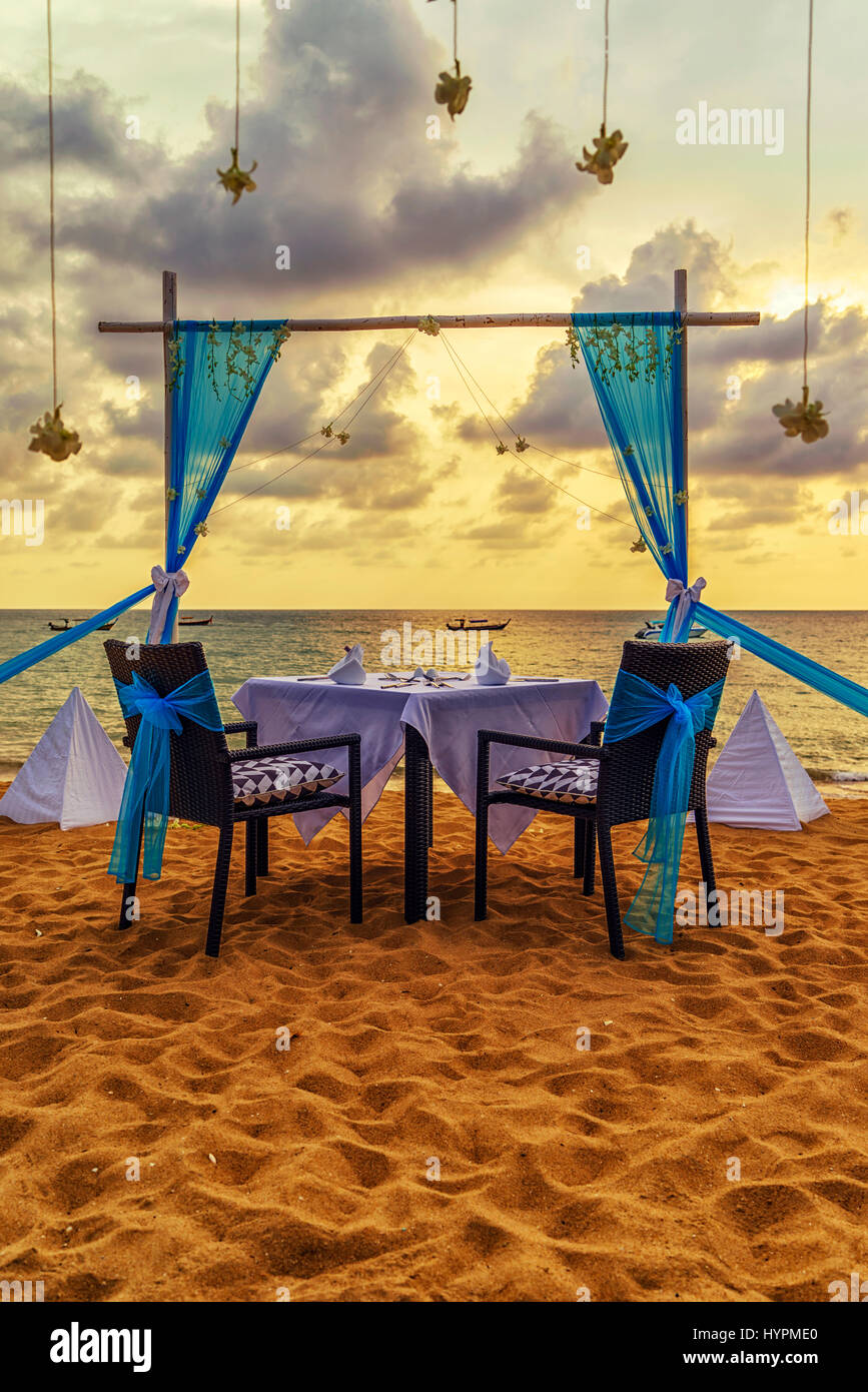 Romantic dinner table set on the beach Stock Photo - Alamy